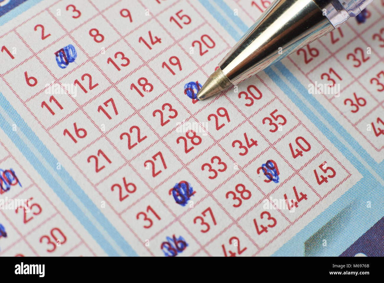 Closeup of hand marking number on lottery ticket with pen Stock Photo ...