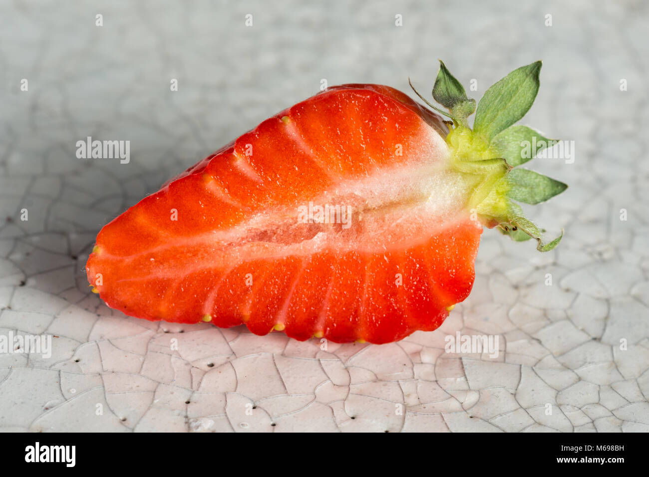 half strawberry on white stone Stock Photo - Alamy