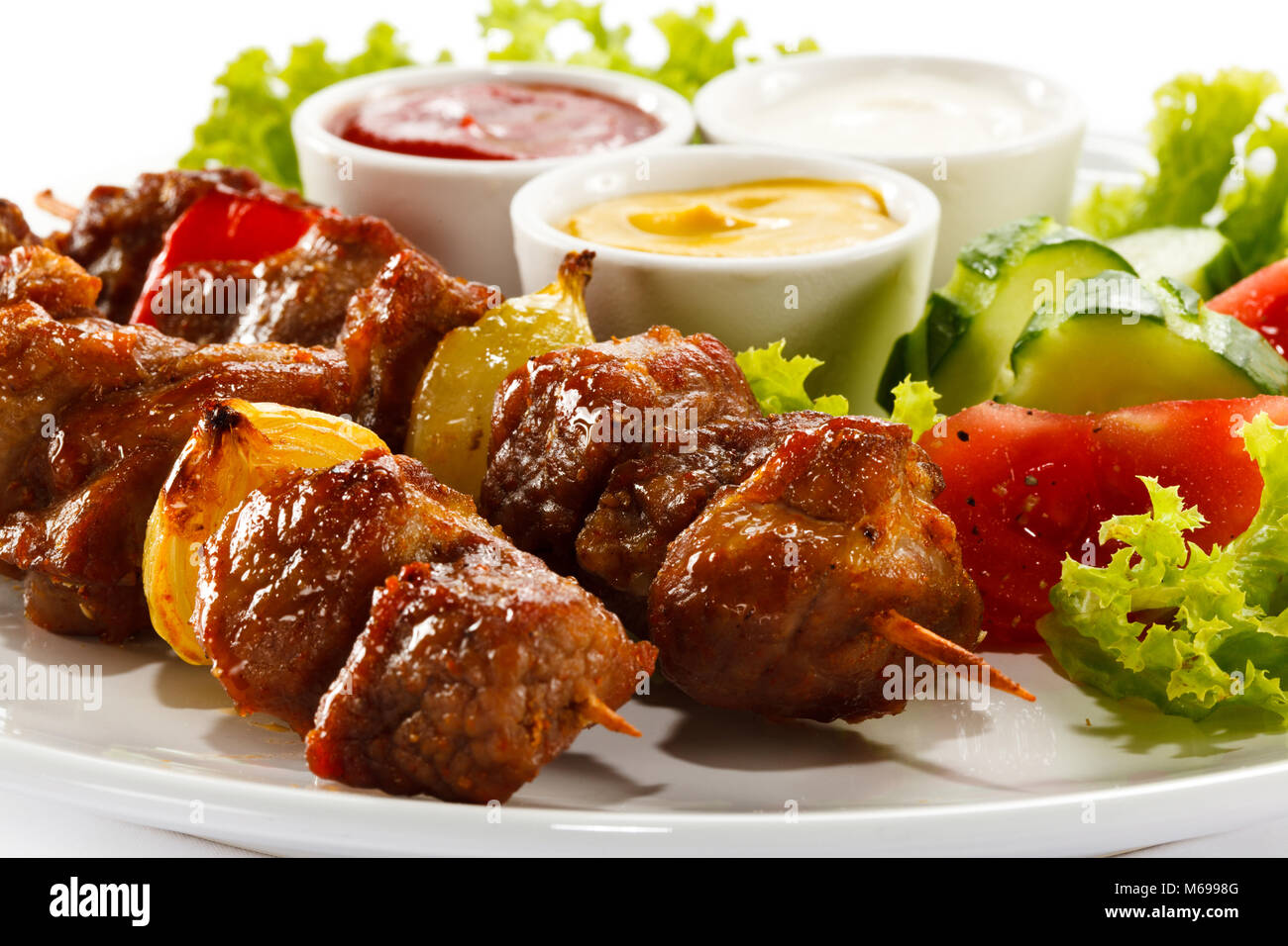 Grilled meat and vegetables on white background Stock Photo - Alamy