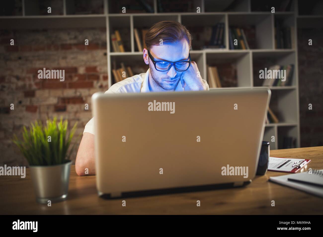 Young man with a laptop Stock Photo - Alamy