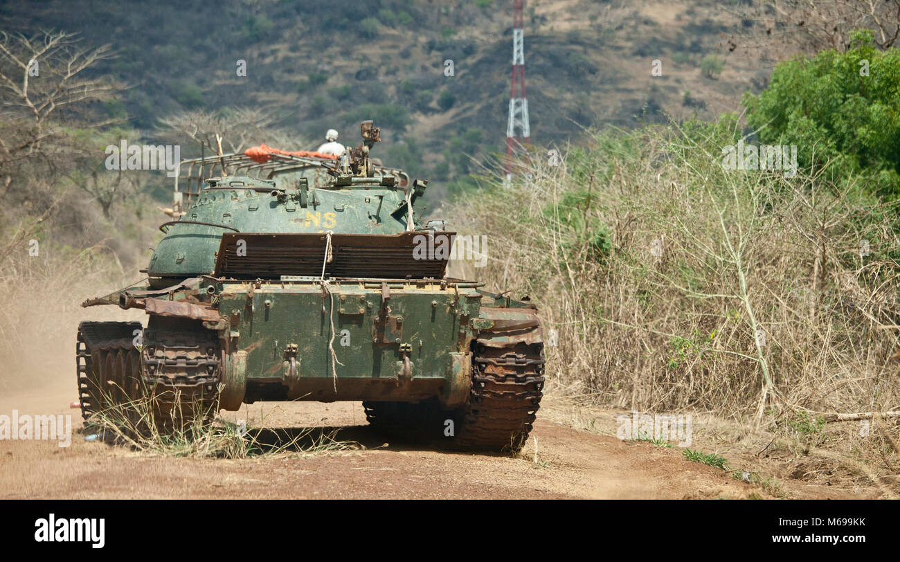 TORIT, SOUTH SUDAN-FEBRUARY 23, 2013: A wrecked tank stands in the road ...