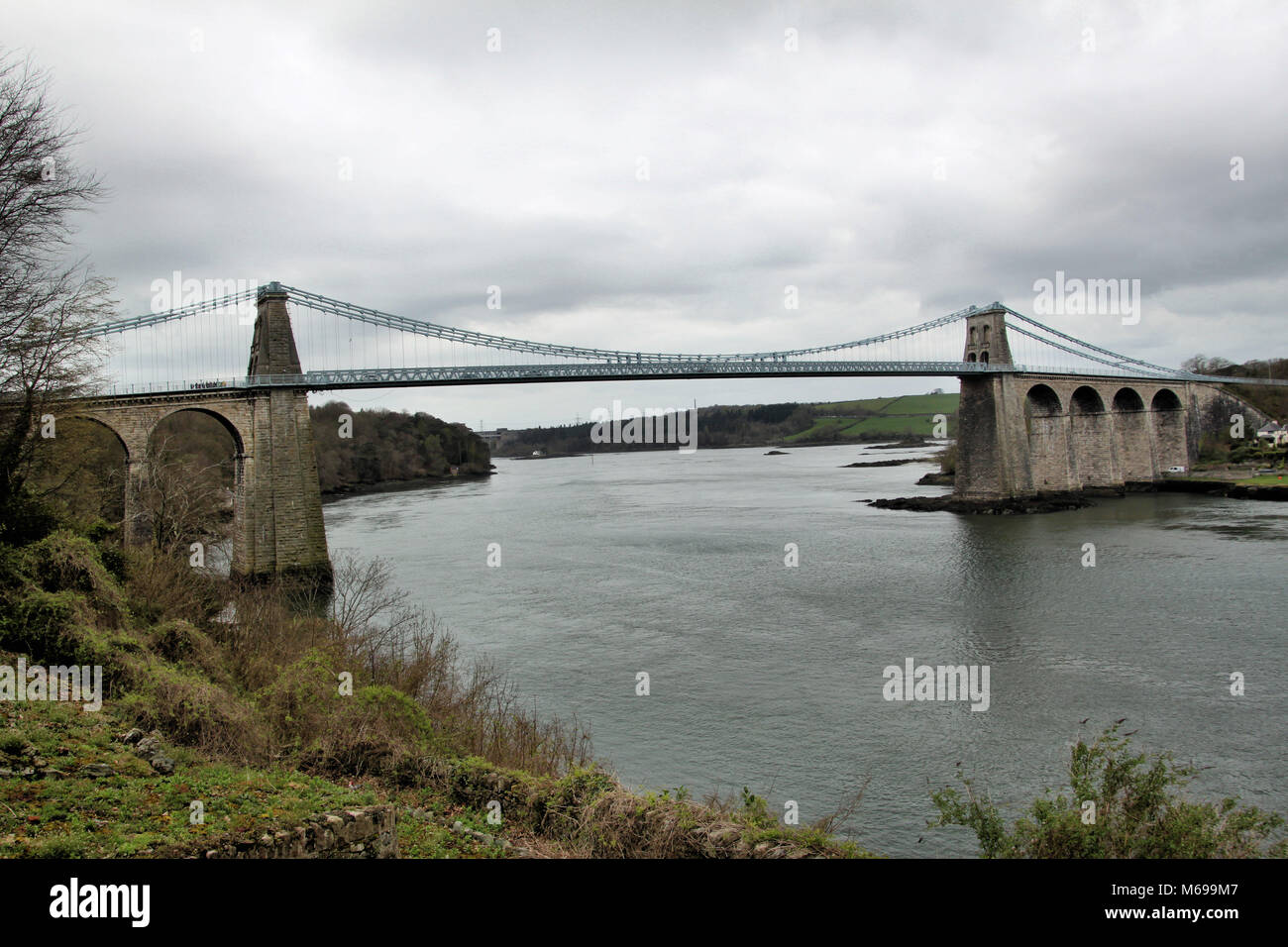 A view of the Menai Suspension Bridge in Anglessey Stock Photo - Alamy