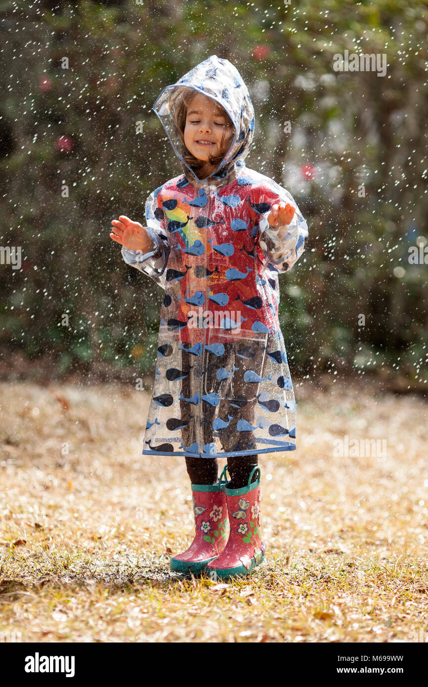 little girl thrilled to be playing in the rain Stock Photo - Alamy