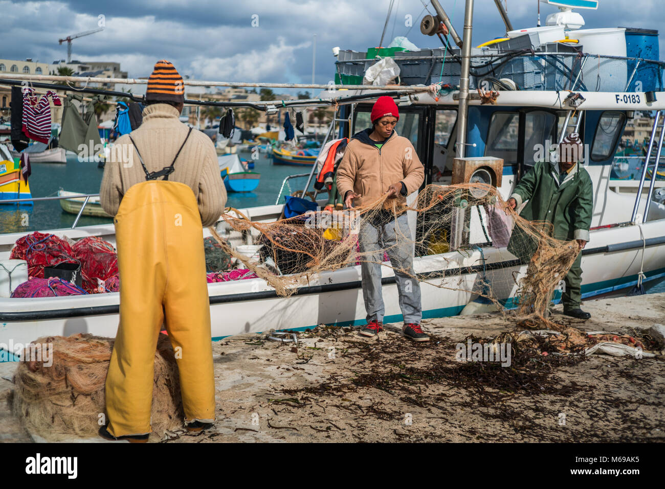 Fisherman in the port of the Marsaxlokk, Malt, Europe Stock Photo - Alamy