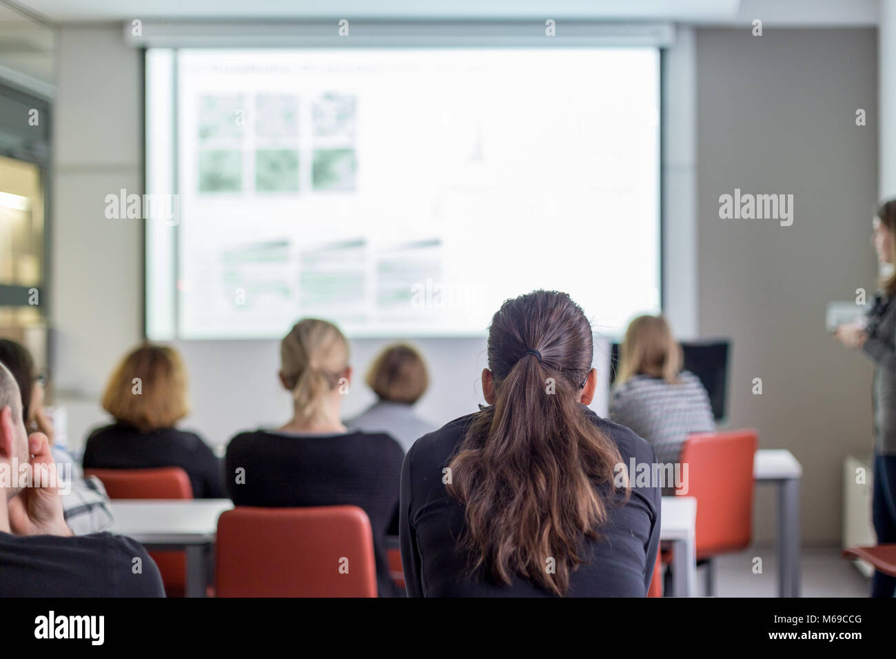 Woman giving presentation on business conference Stock Photo - Alamy