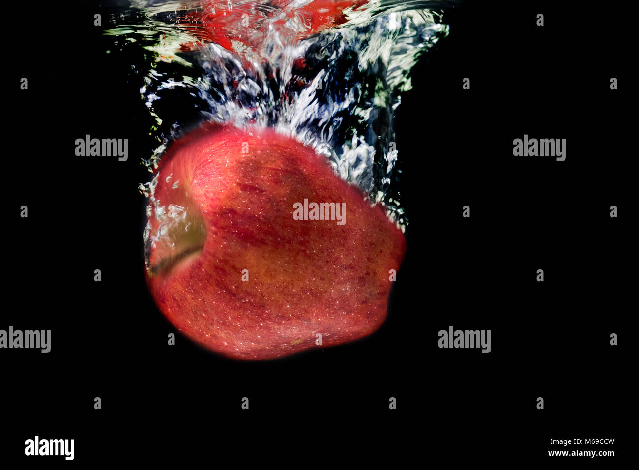 Red apple in water splash isolated on a black background Stock Photo ...