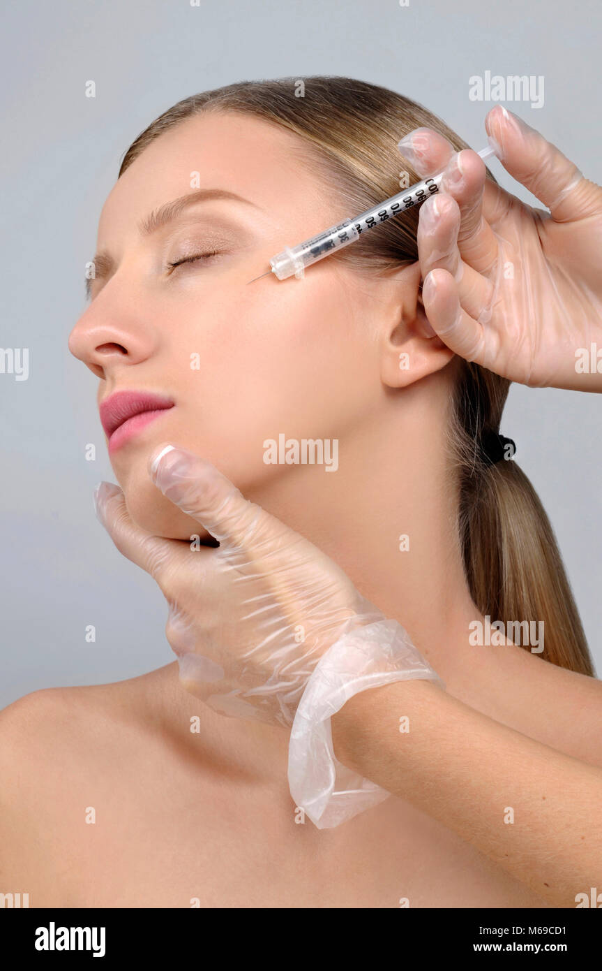 Woman is getting botox injection. Anti-aging treatment and face lift ...