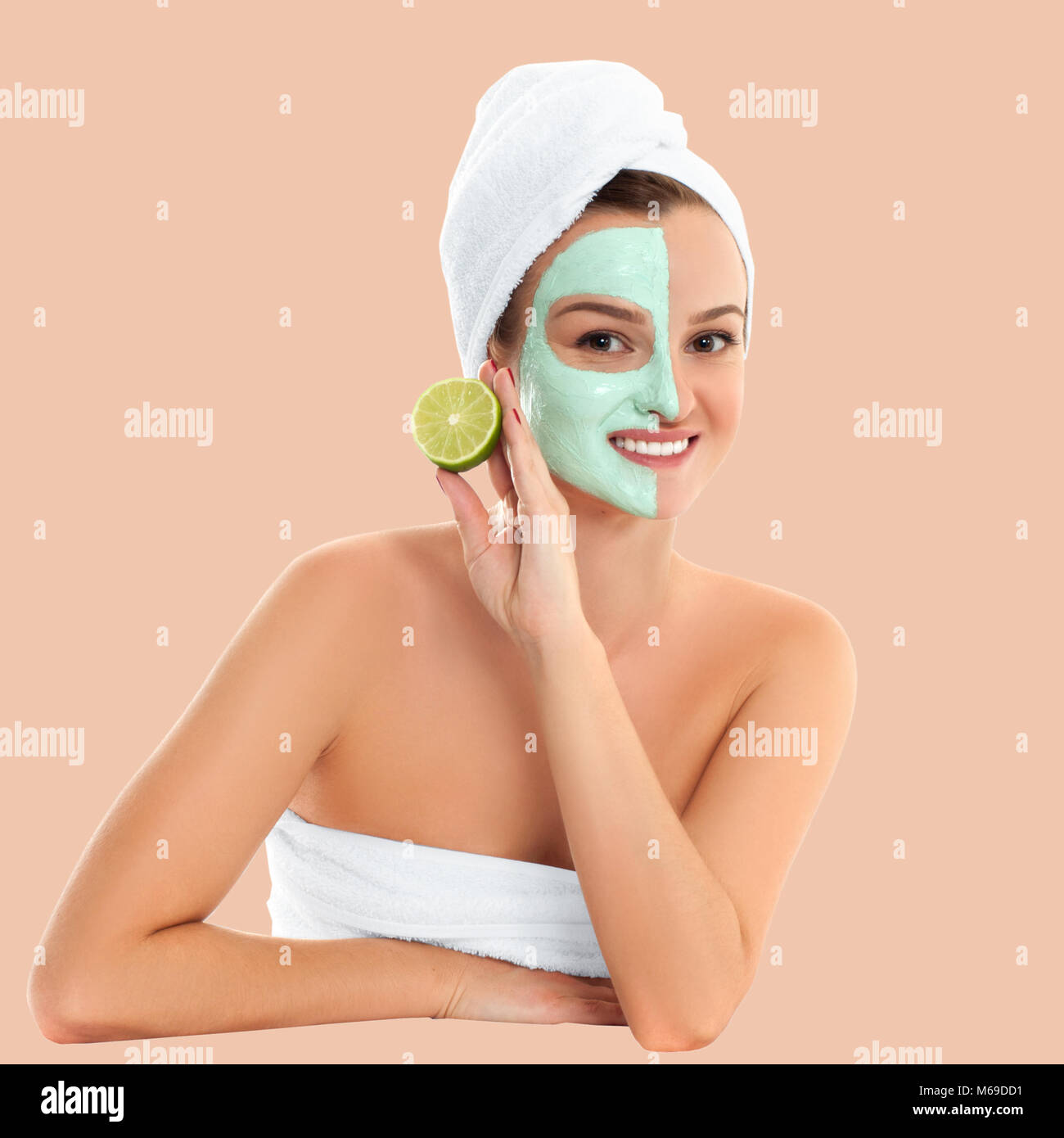 Beautiful Woman Is Getting Facial Clay Mask On Pastel Background