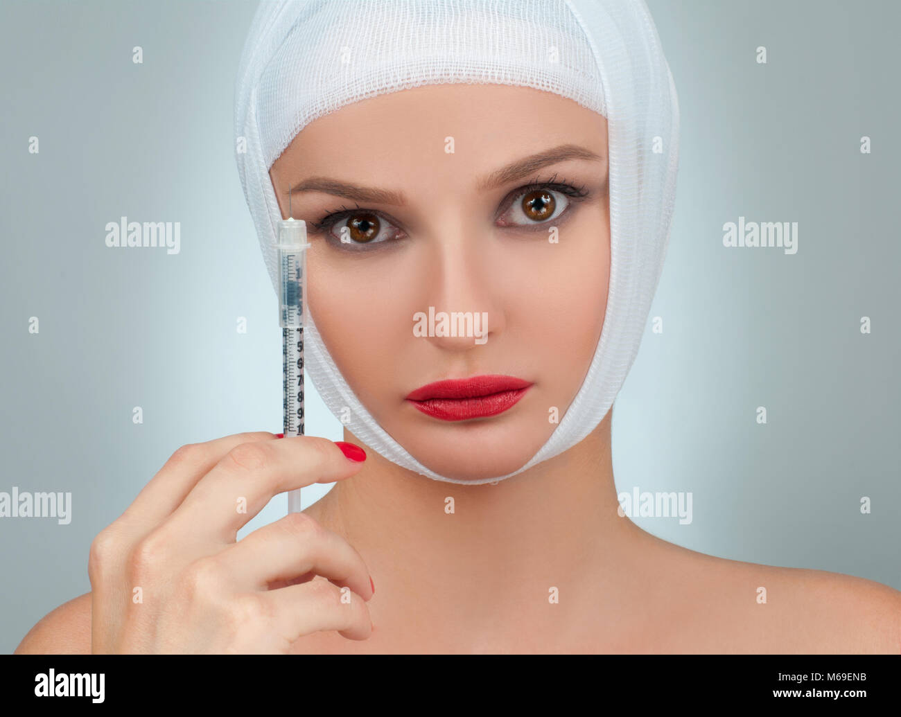 Woman with syringe. Beautiful woman after plastic surgery with bandaged ...