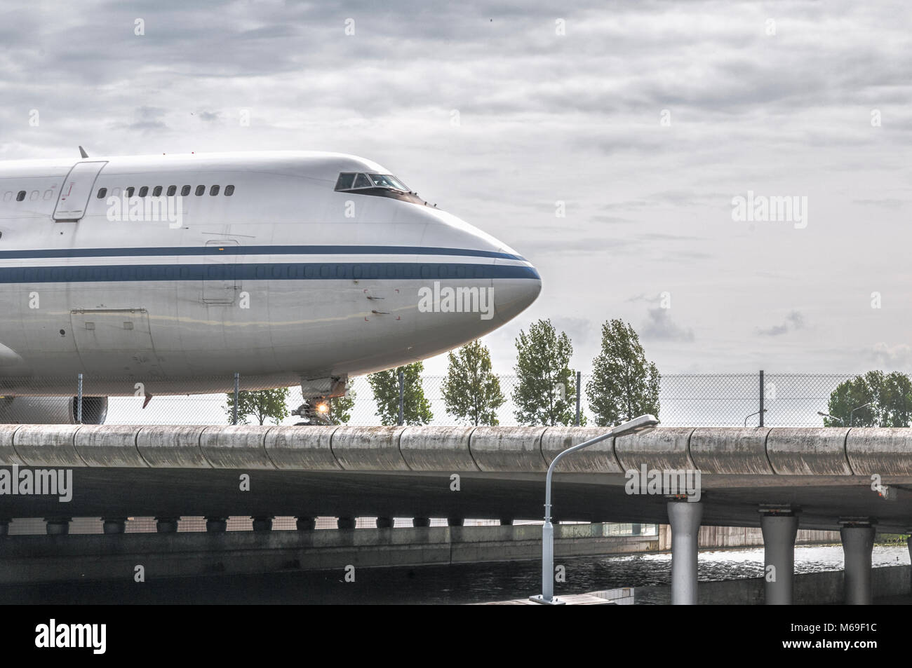 front of a plane driving over a runway bridge Stock Photo - Alamy