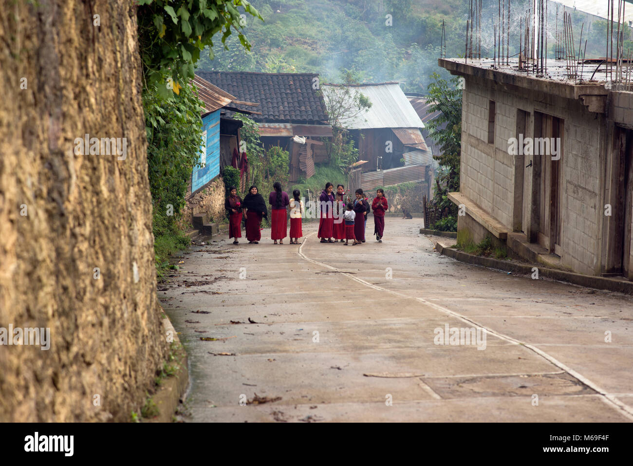 A typical street scene with people talking in a small, indigenous Ixil ...