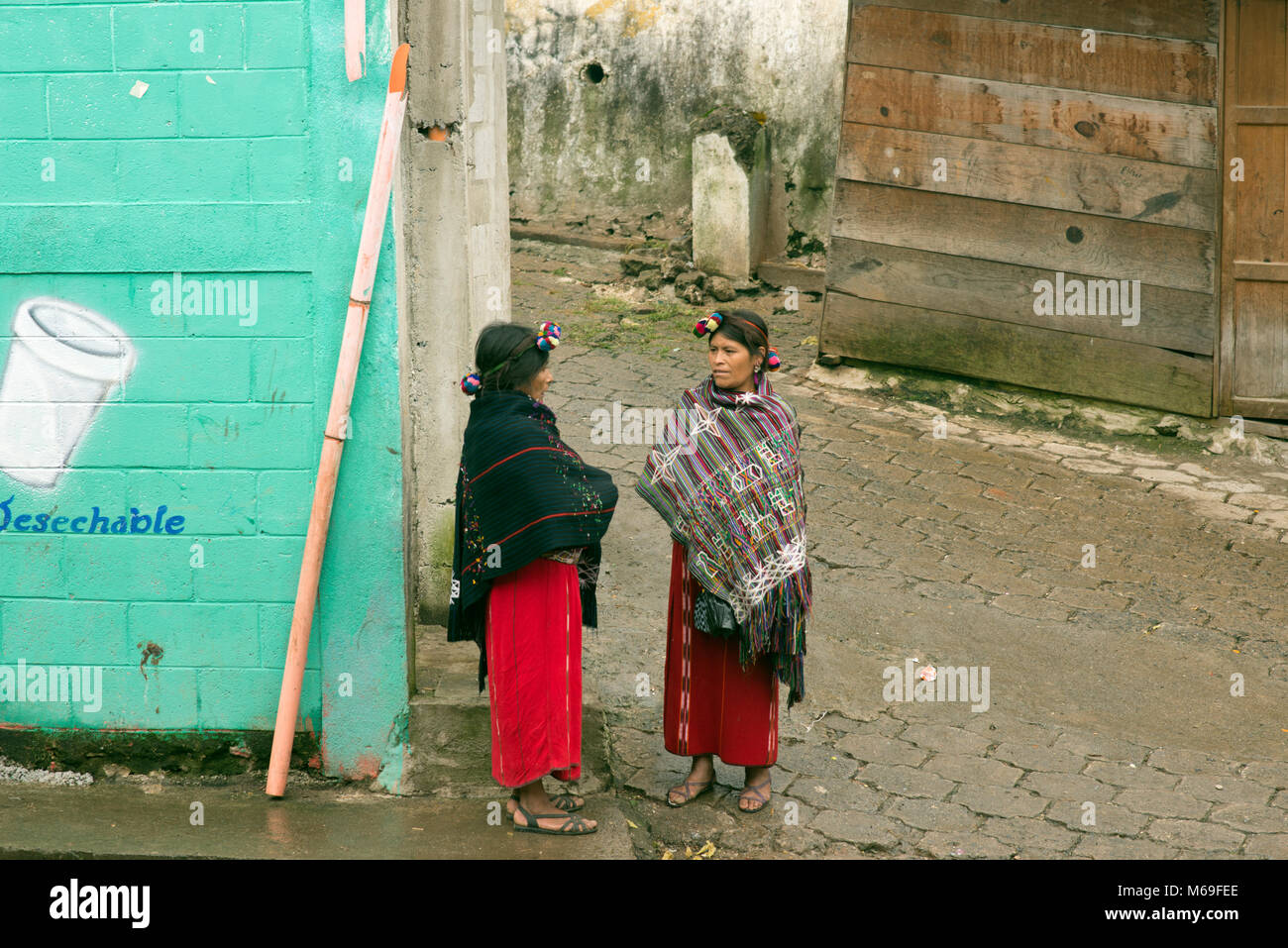 Two indigenous ethnic Ixil Maya women wearing colourful clothes talking ...