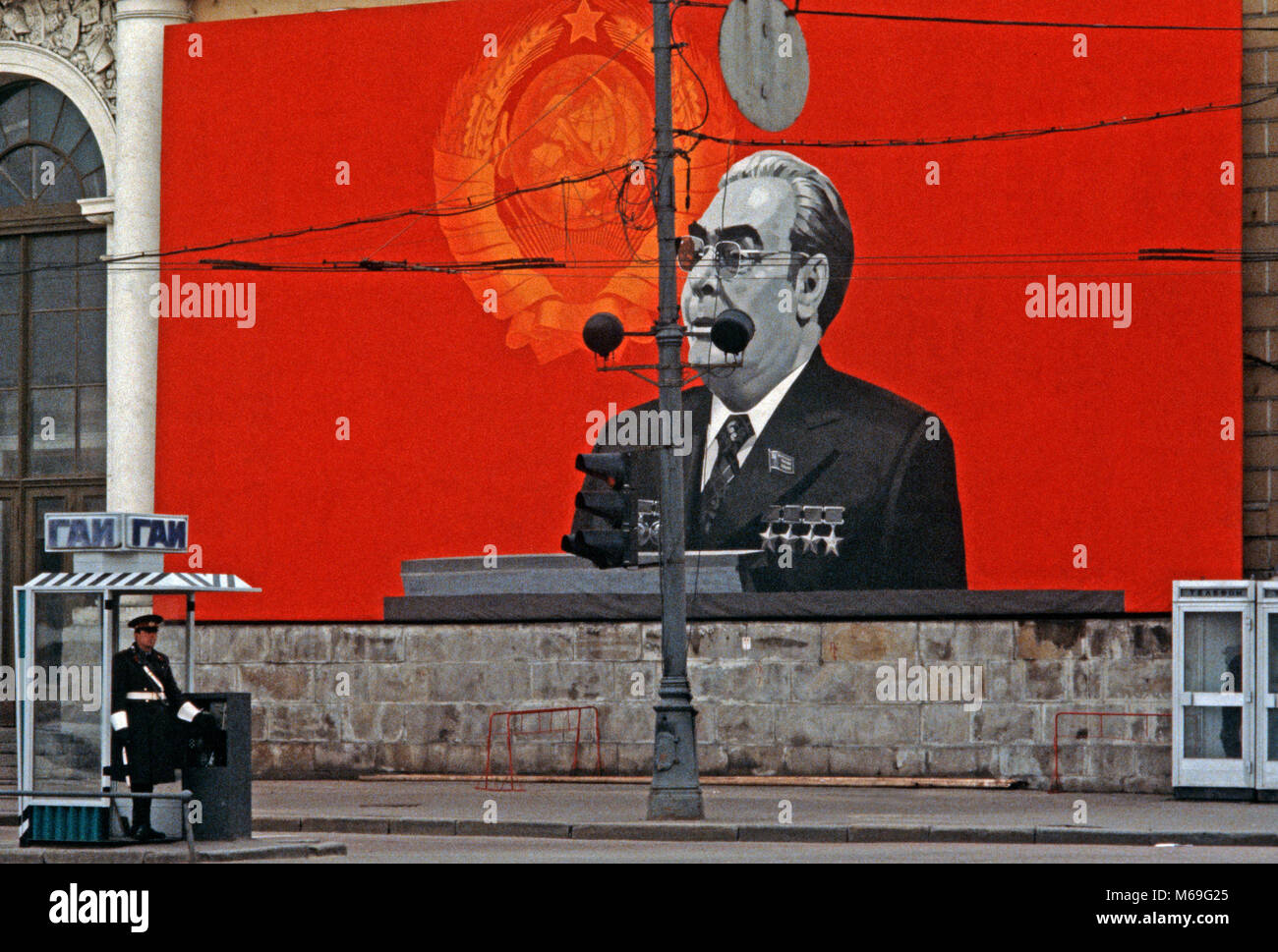 Traffic policeman infront of large poster of Leonid Brezhnev, former ...