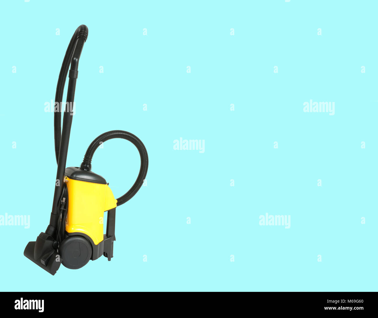 Yellow vacuum cleaner on pastel yellow green background Stock Photo - Alamy