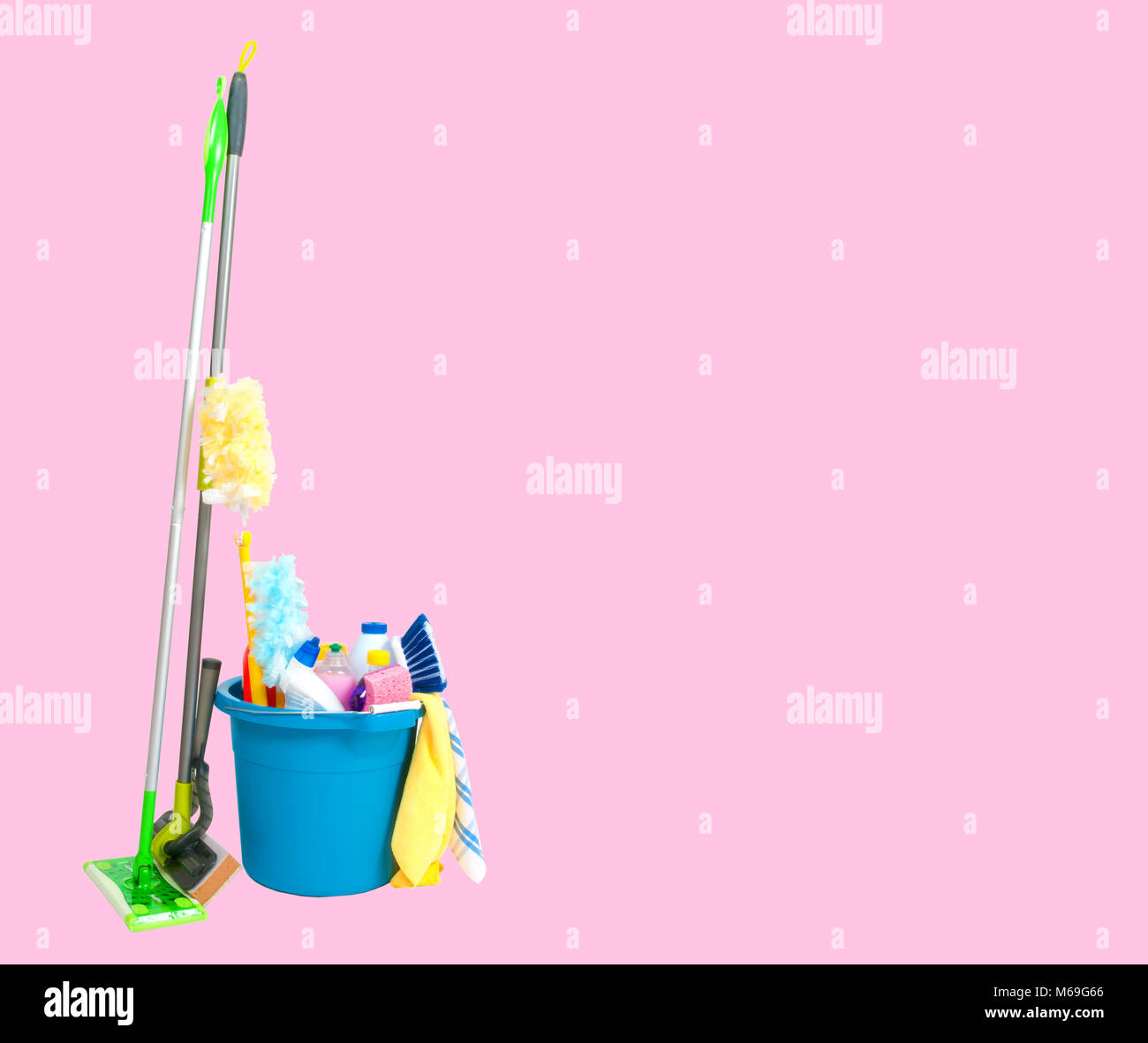 Variety of cleaning products in bucket on pastel pink background Stock ...