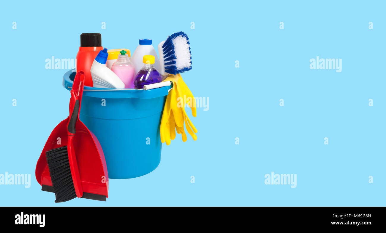 Variety of cleaning products in bucket on pastel blue background Stock ...