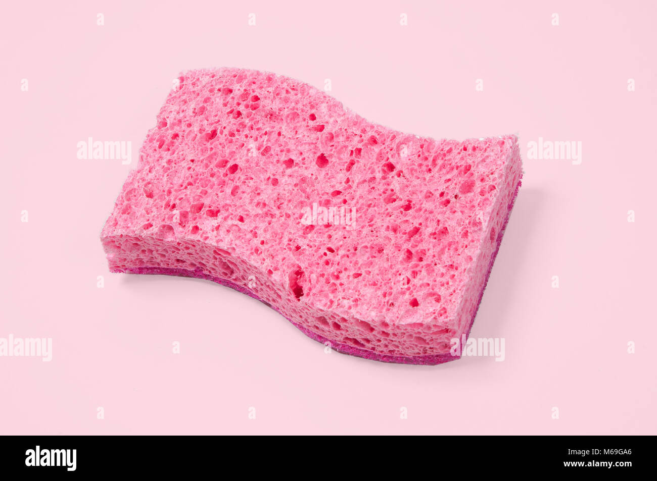 Pink sponge for dishes on faded pastel background. Cleaning tool ...