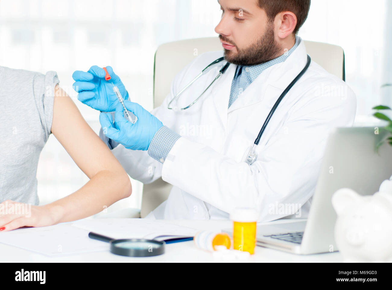 Vaccination. Flu shot. Doctor with syringe making vaccination to ...