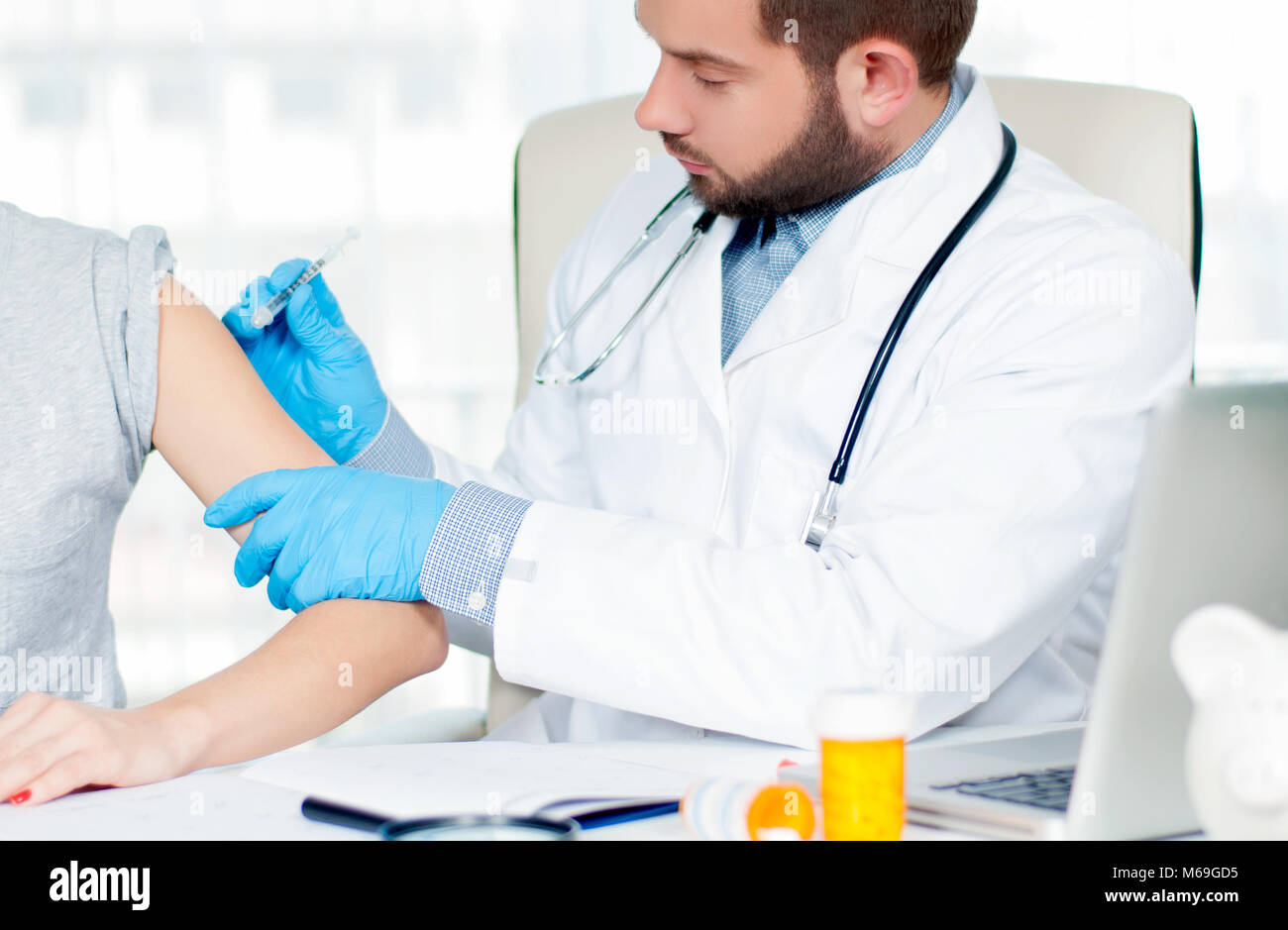 Vaccination. Flu shot. Doctor with syringe making vaccination to ...