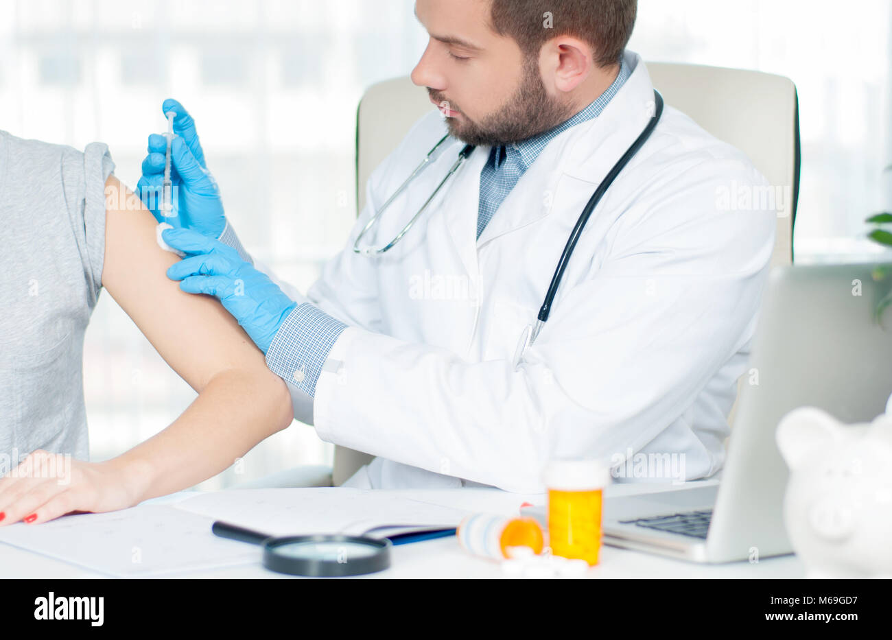 Vaccination. Flu shot. Doctor with syringe making vaccination to ...