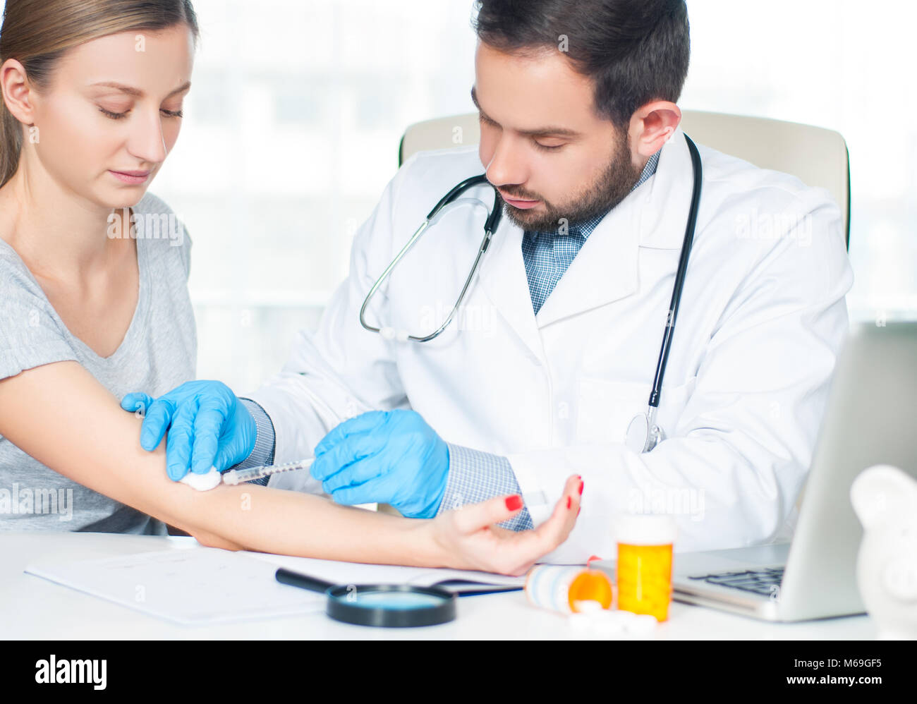 Vaccination. Flu shot. Doctor with syringe making vaccination to ...