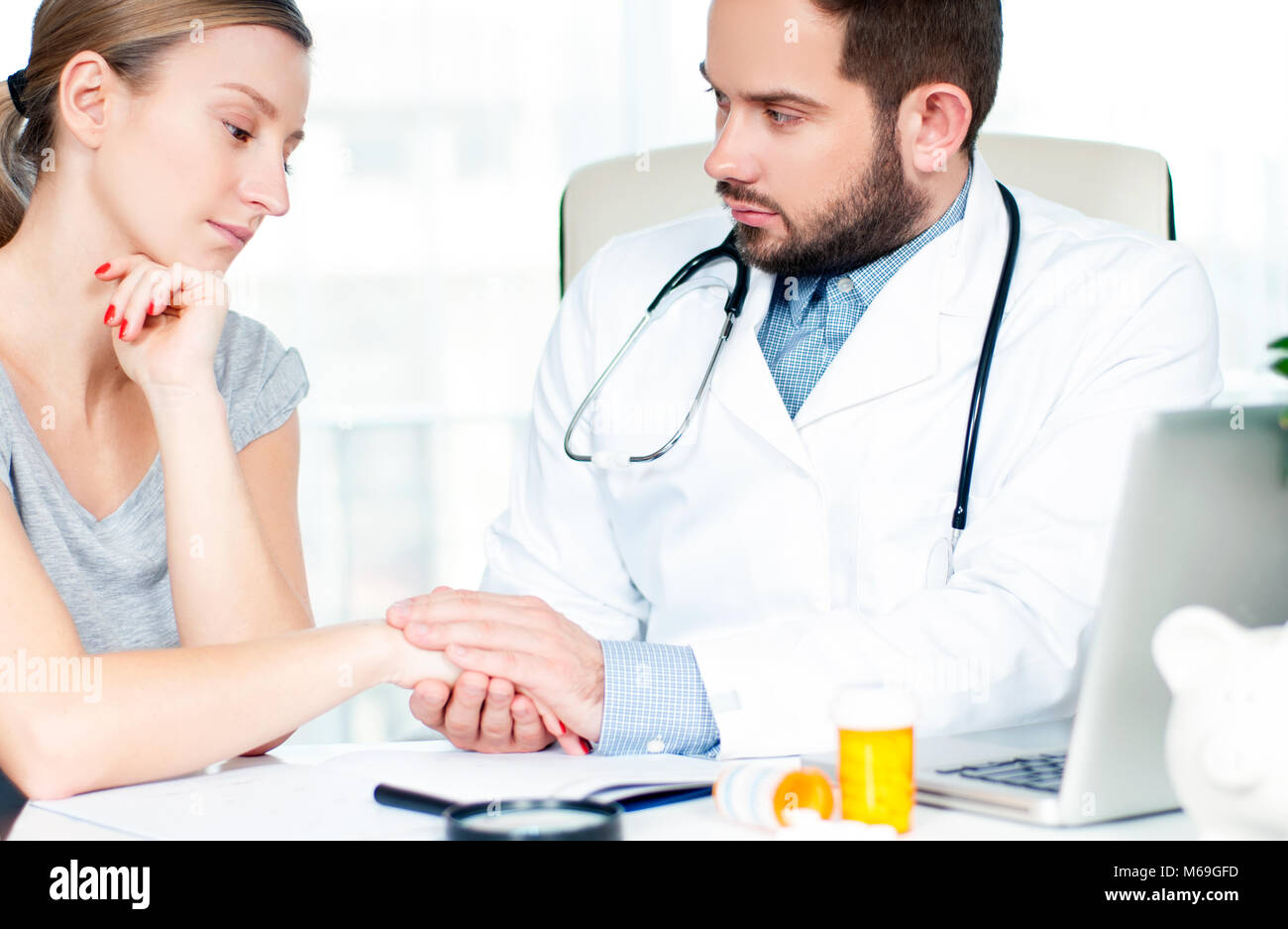 Doctor and patient. Hand of doctor reassuring her woman patient Stock ...