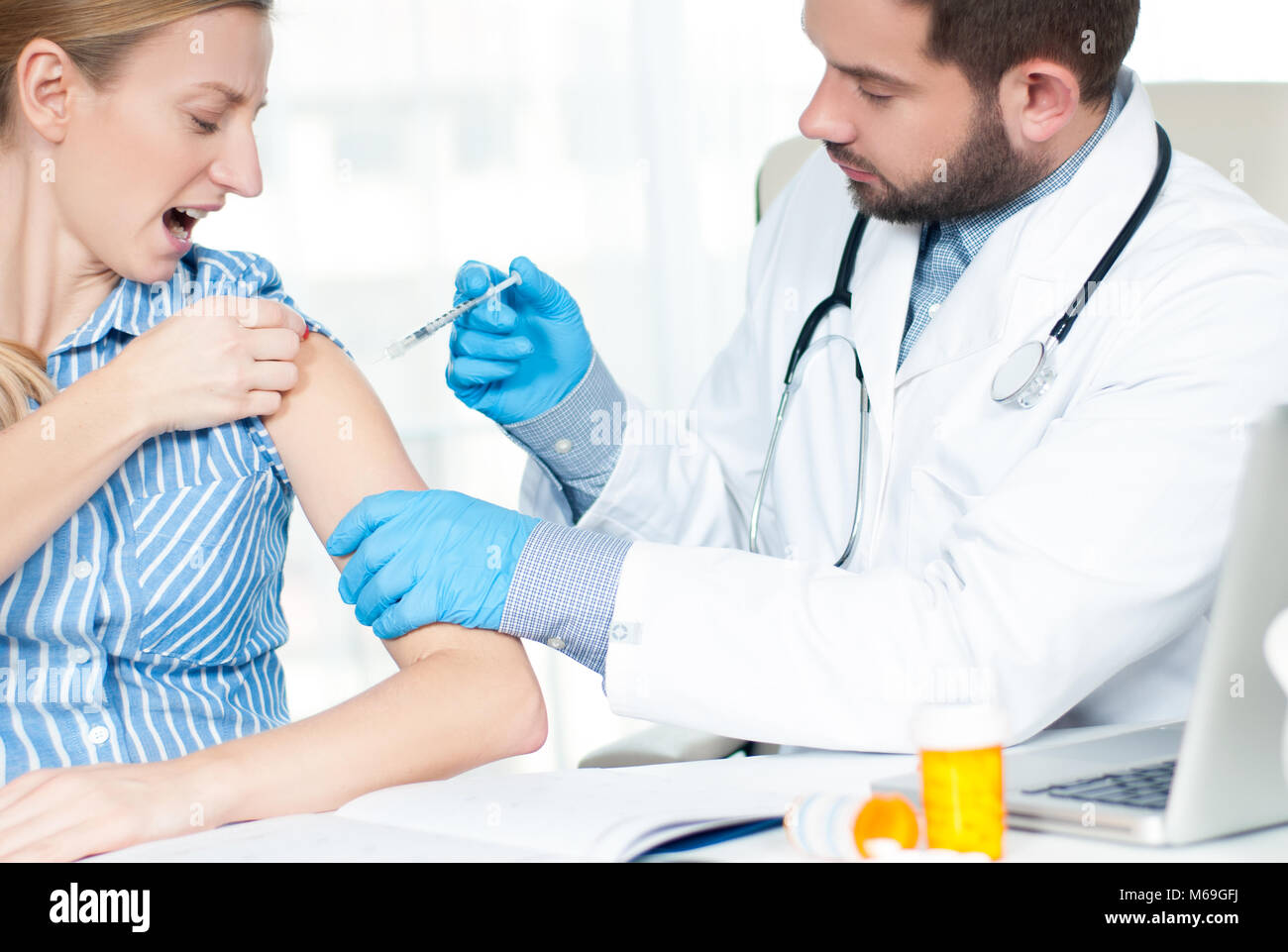 Vaccination. Flu shot. Doctor with syringe making vaccination to ...