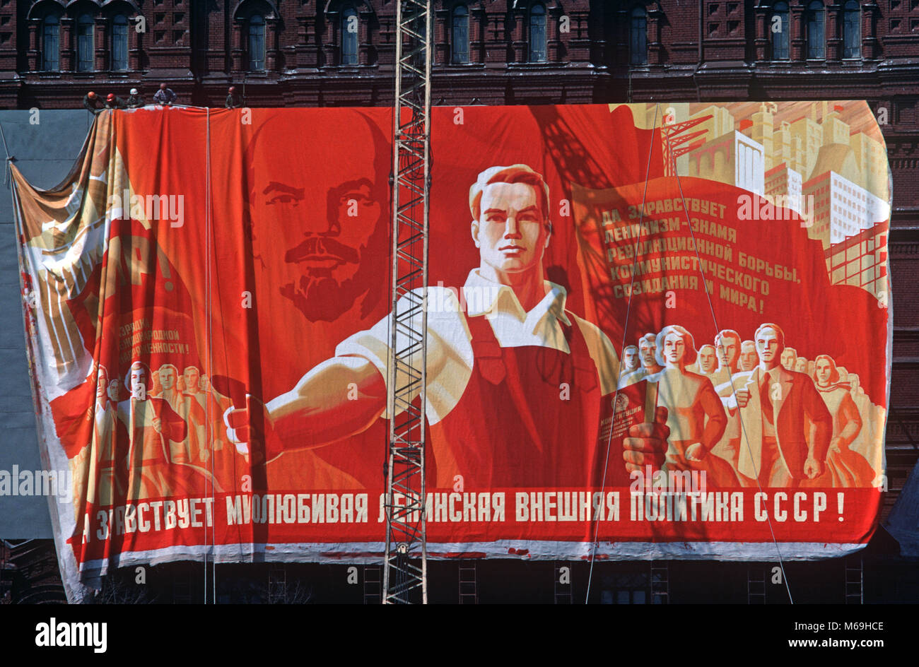 Taking down of workers political banner with portrait of Lenin ...