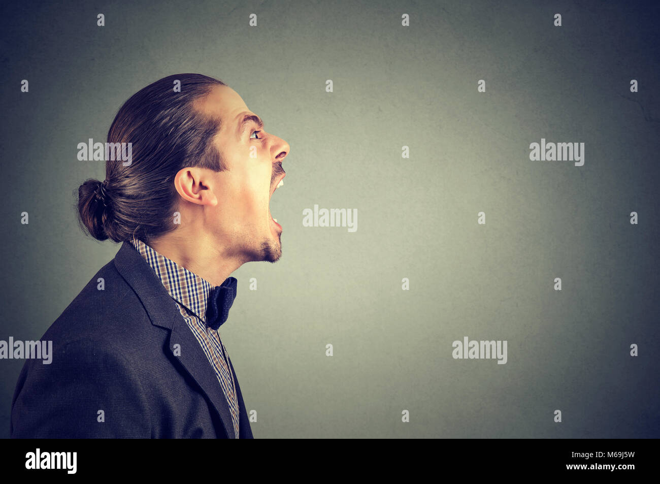 Side view of angry business man yelling in madness looking away Stock ...