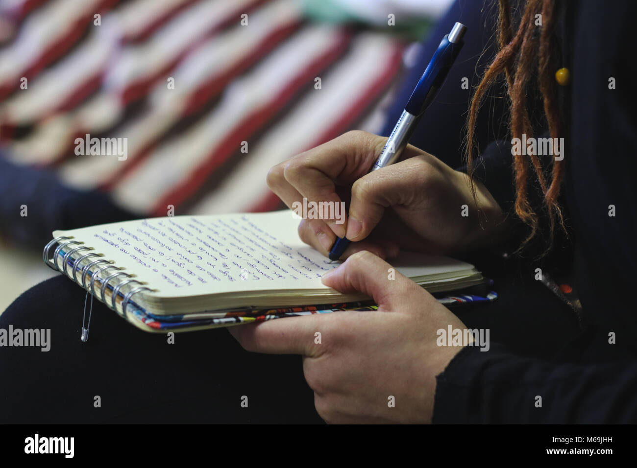 Notebook and hands Stock Photo - Alamy