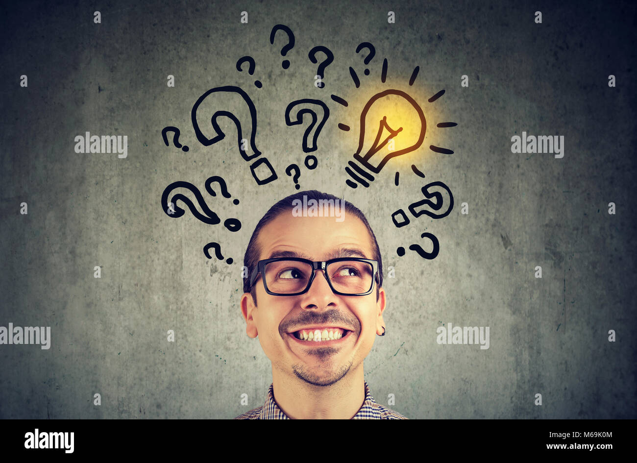 Business man with many questions and solution light bulb above head ...