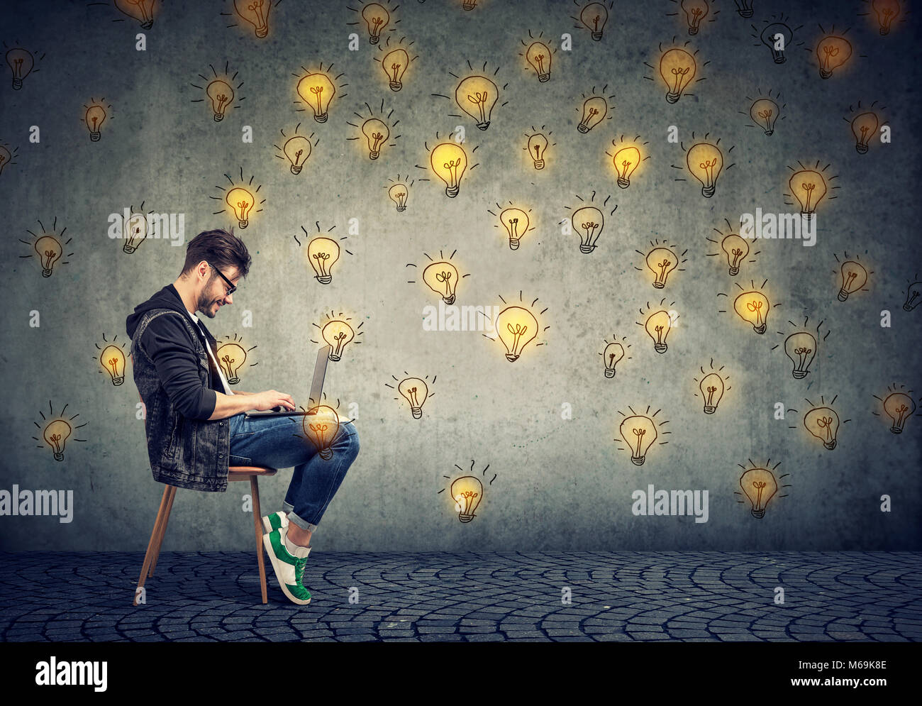 Young happy man entrepreneur working on laptop computer has plenty of ...