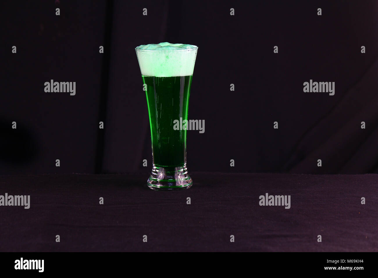 Green beer in a pilsner glass Stock Photo - Alamy