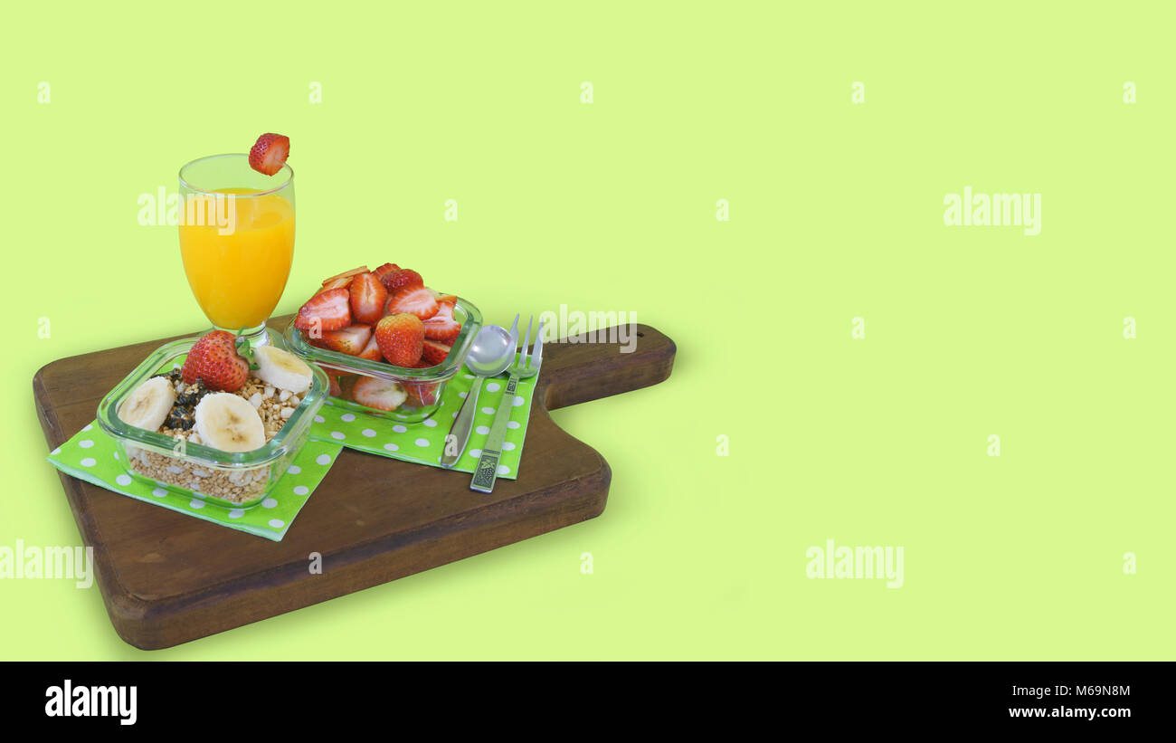 Healthy breakfast. Glass pot with chopped strawberries, glass pot with ...