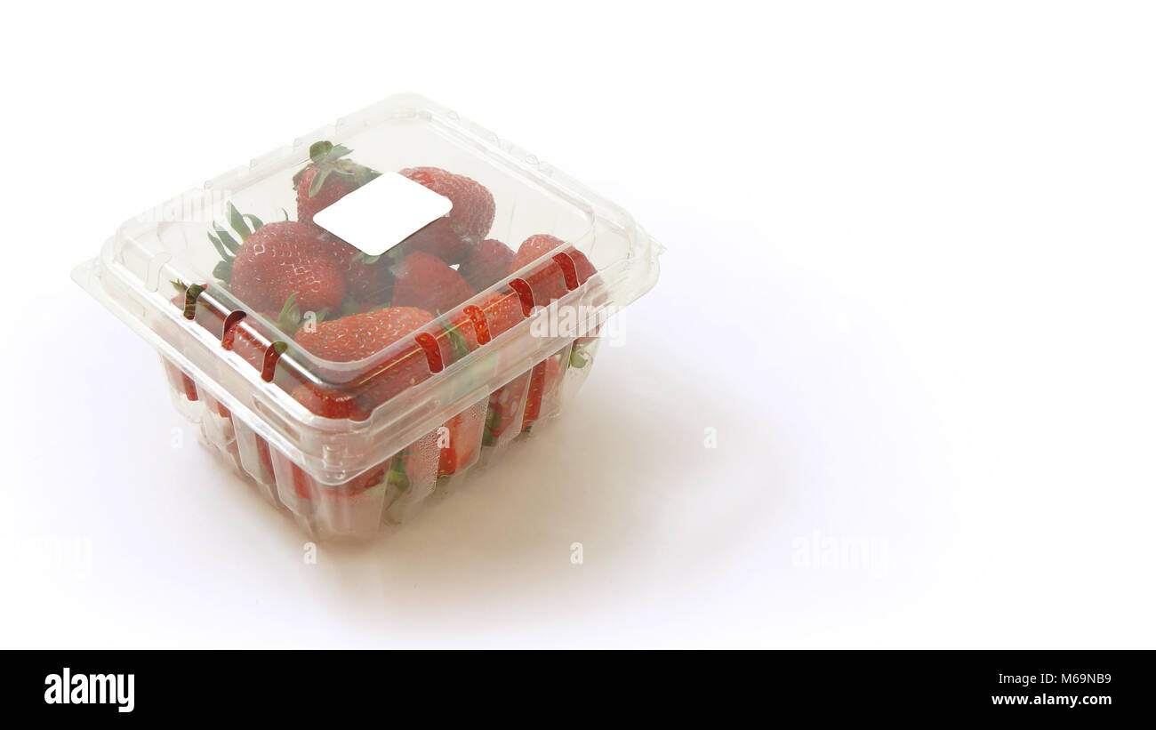 Approach to a transparent plastic box with fresh strawberries inside on ...