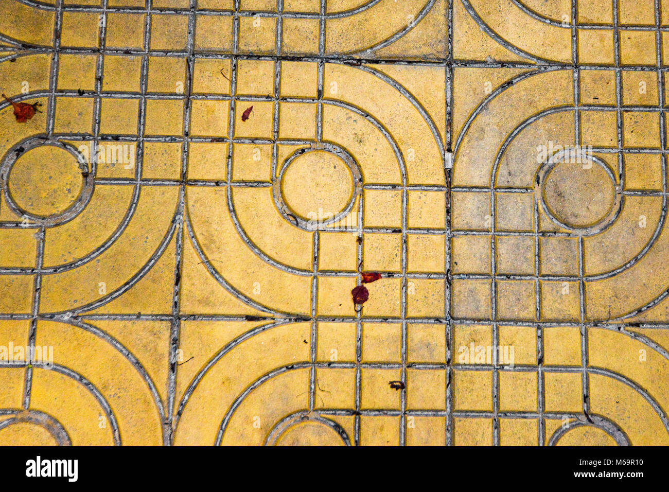 yellow patterned paving tiles on the street, top view. Cement bricks ...