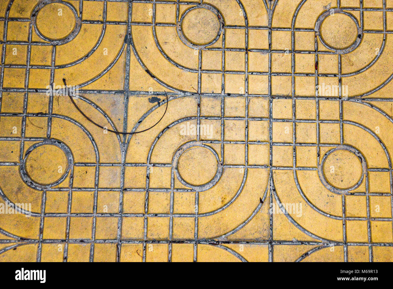 yellow patterned paving tiles on the street, top view. Cement bricks ...