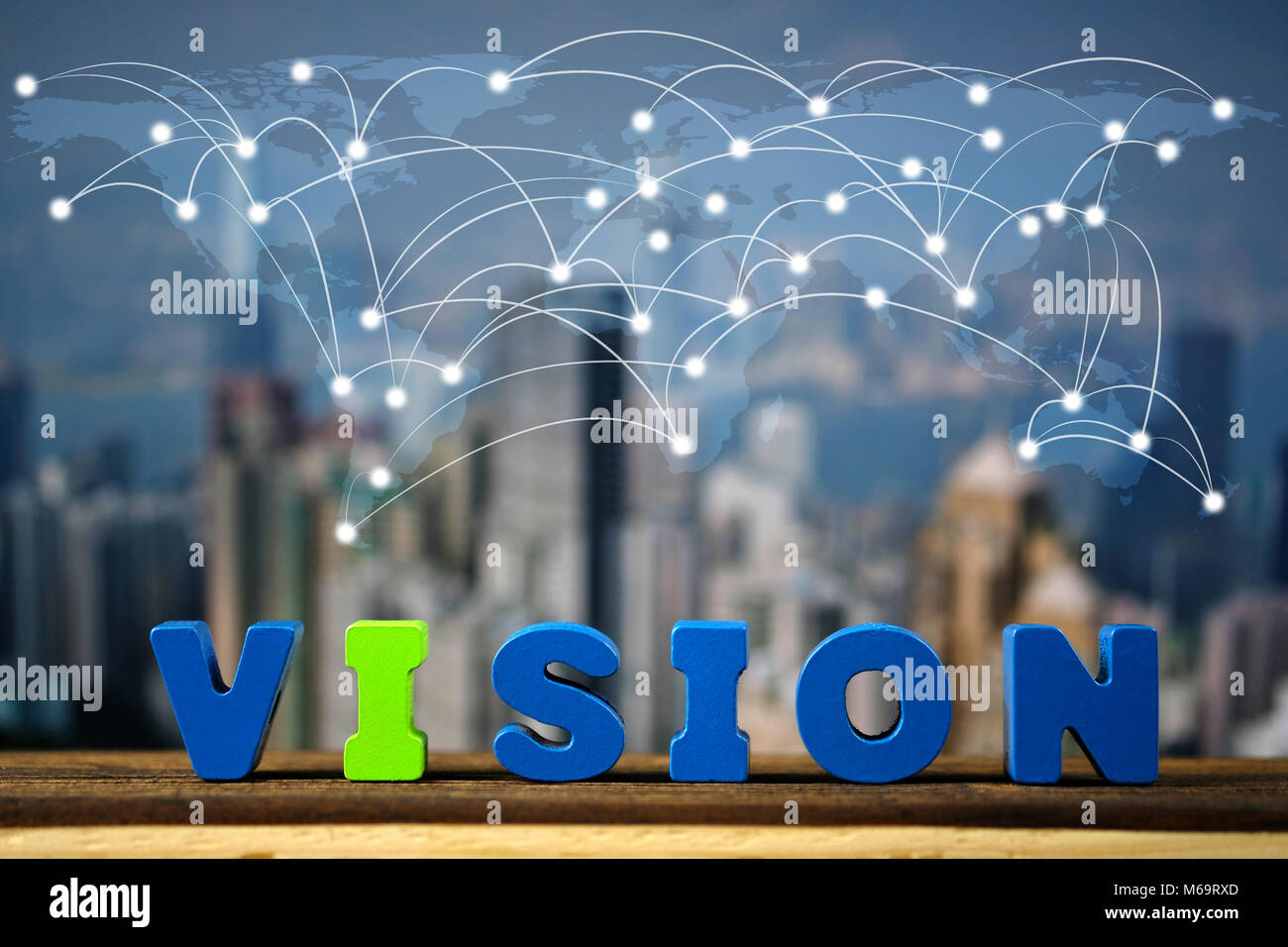 VISION text on top wooden working table with city background and world ...