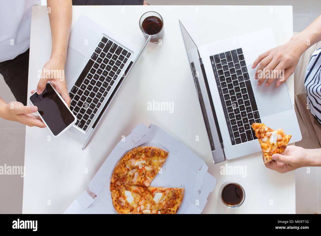 People eat fast food. Happy business team eating pizza in office Stock ...