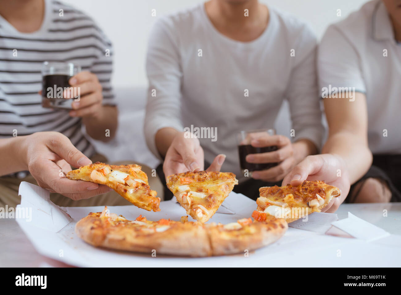 People eat fast food. Friends hands taking slices of pizza Stock Photo ...