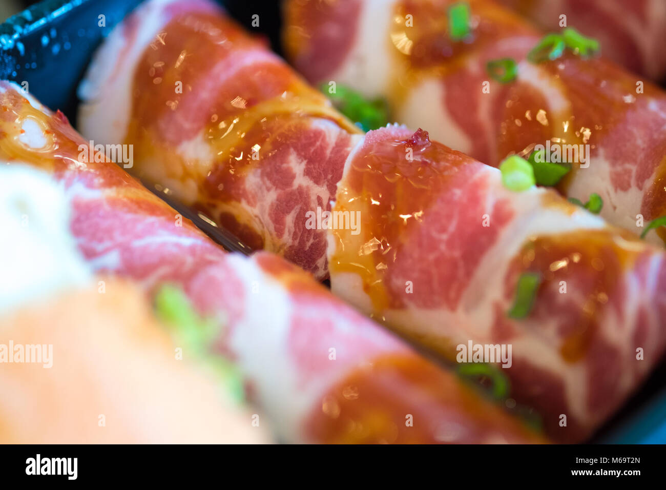 Raw kurobuta pork slices on plates, for sukoyaki and yakiniku hot pot ...