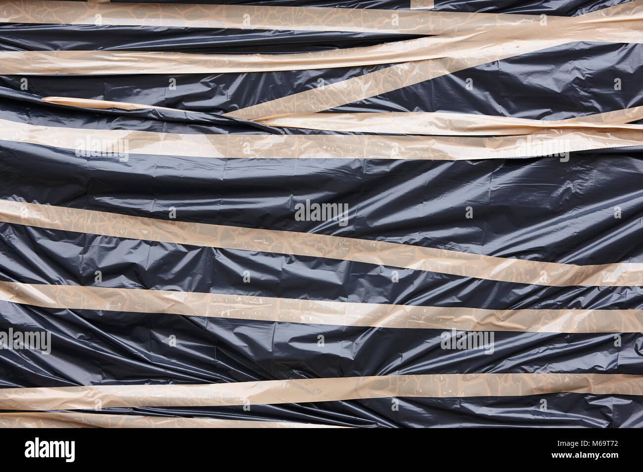 Black plastic protection with adhesive tape. Storage packaging ...