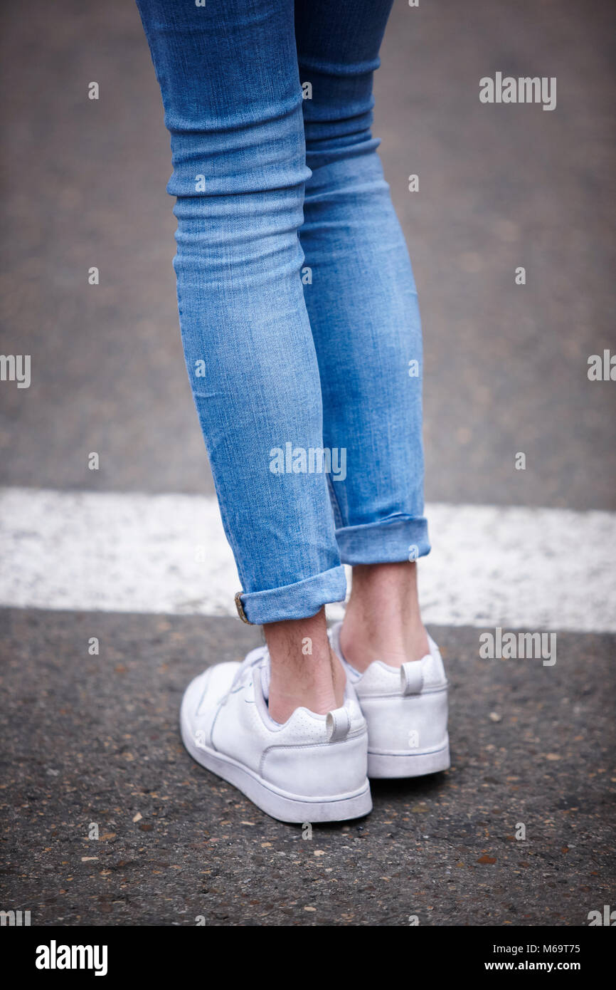 Male legs with jeans and sneakers. Hipster trendy people. Vertical ...
