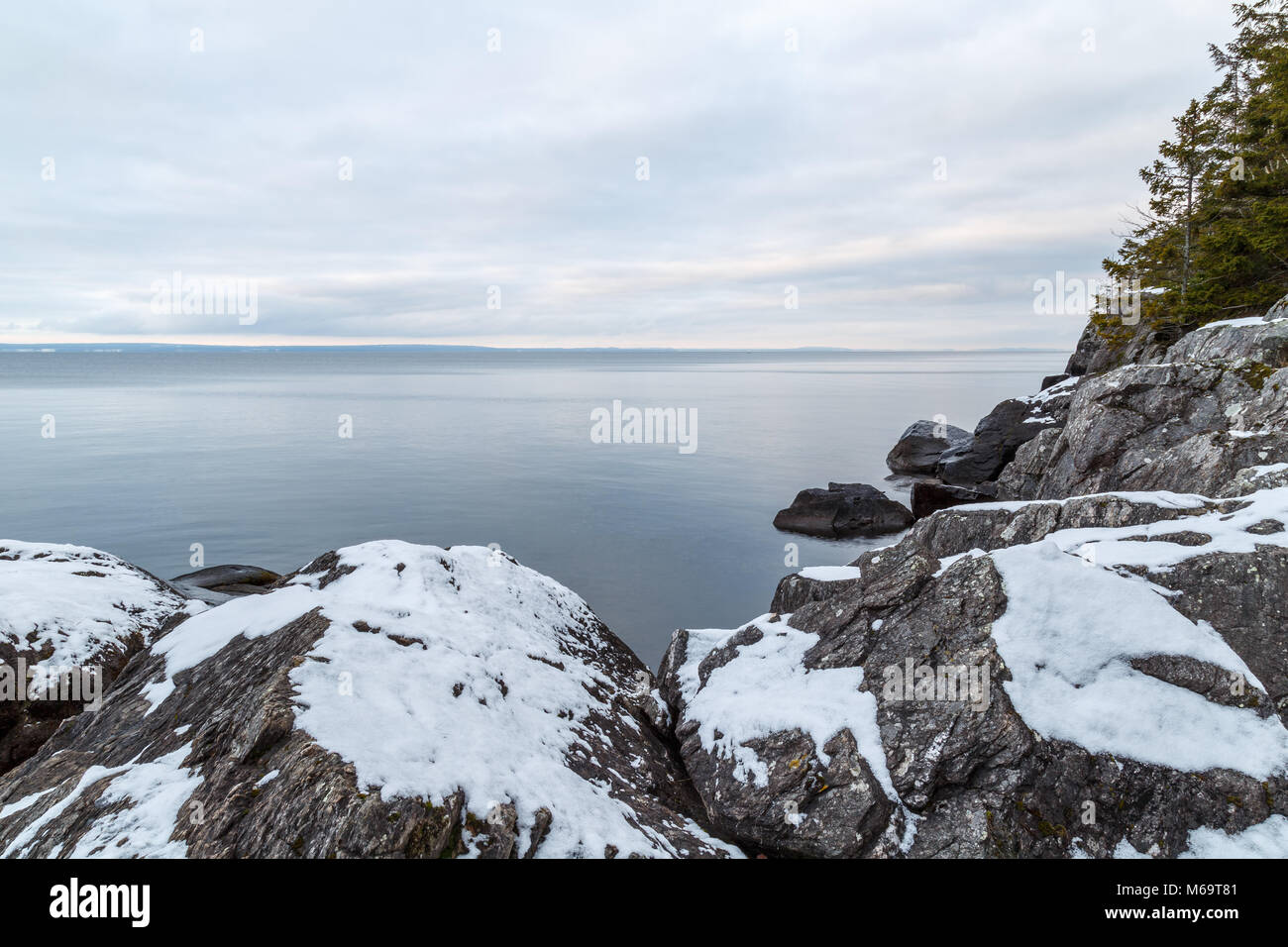 Cliffs at sea in winter with snow Stock Photo - Alamy