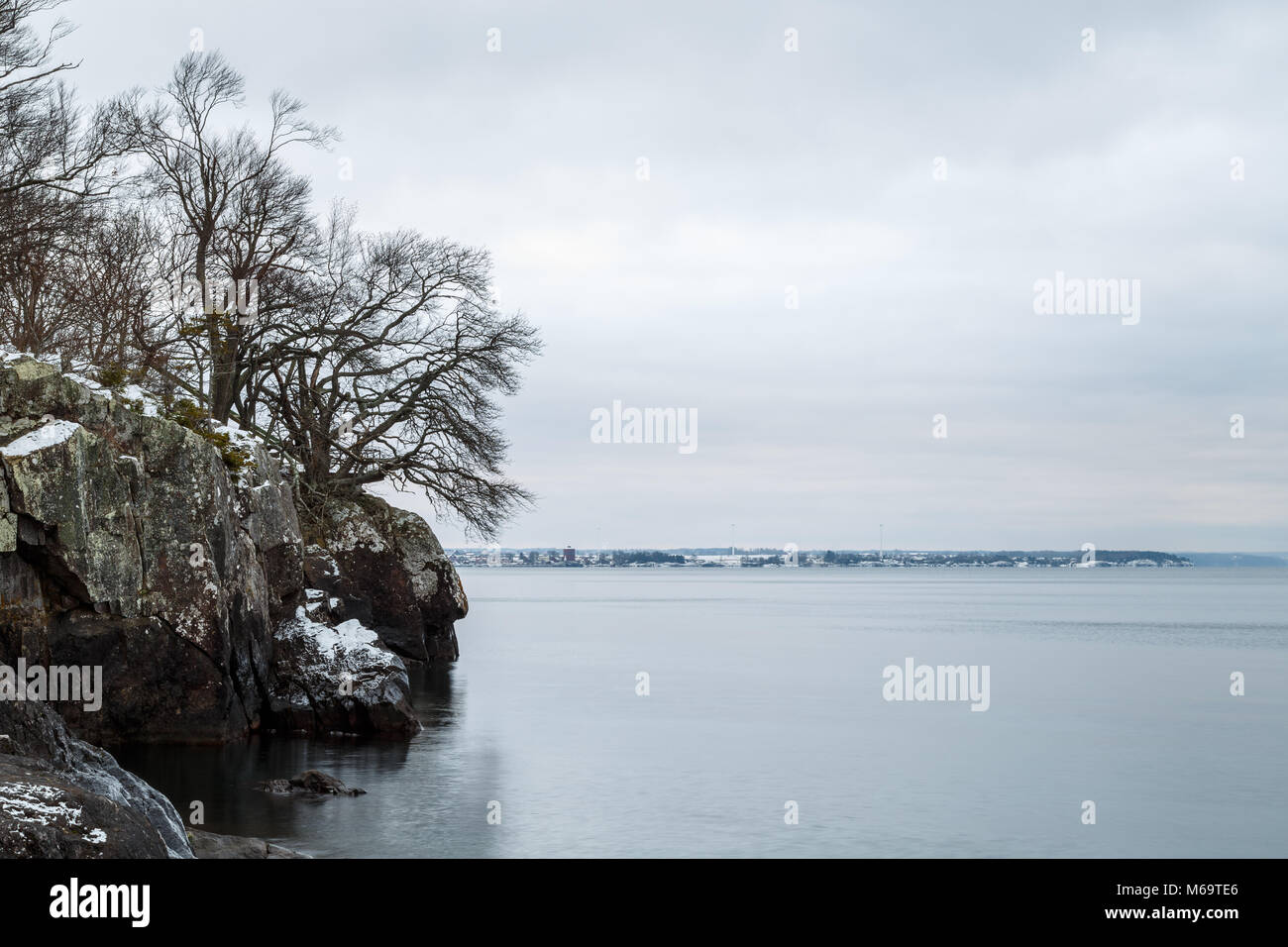 Cliffs at sea in winter with snow Stock Photo - Alamy