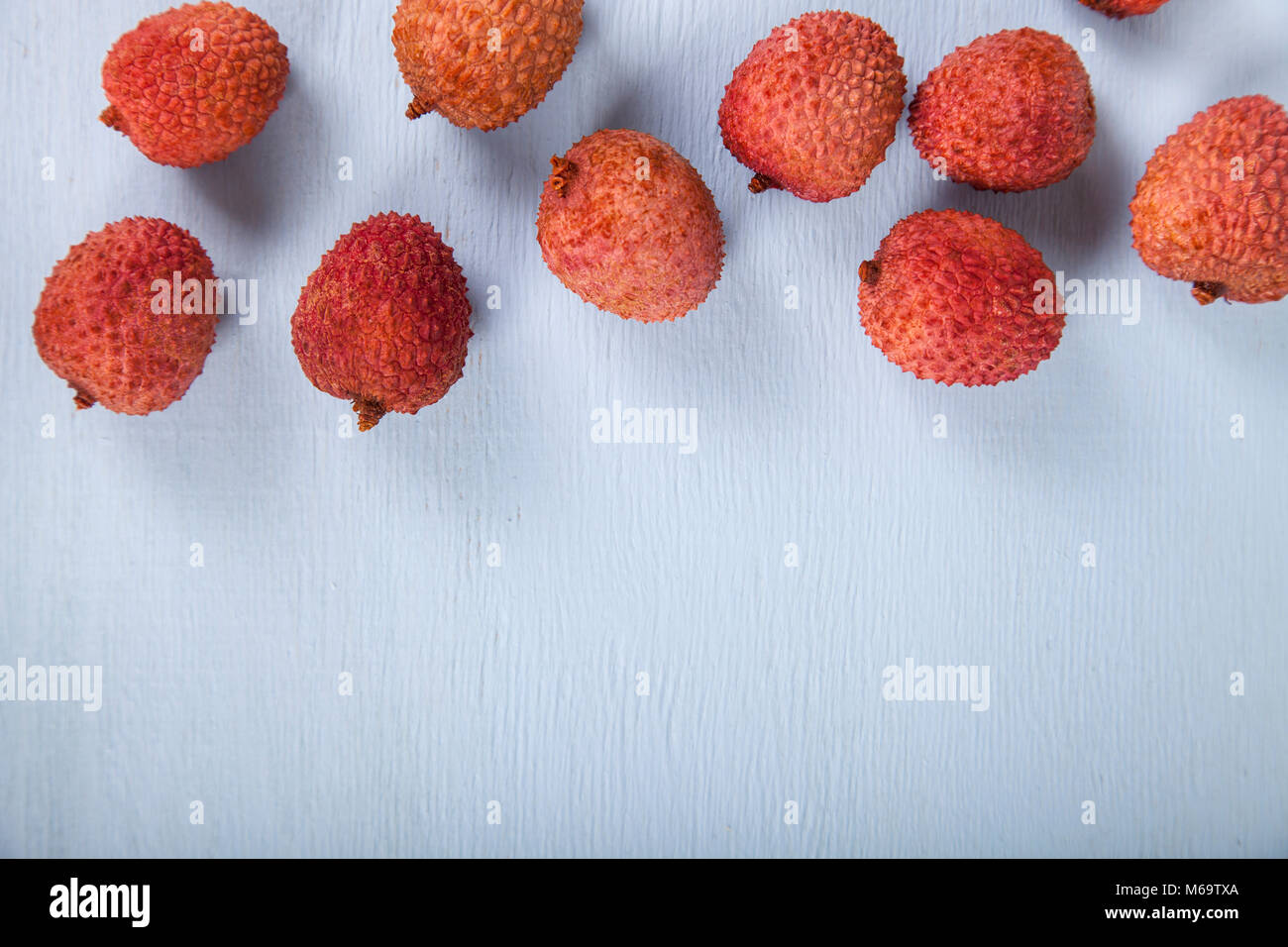 Lychee on a blue table. Delicious tropical fruit Stock Photo - Alamy