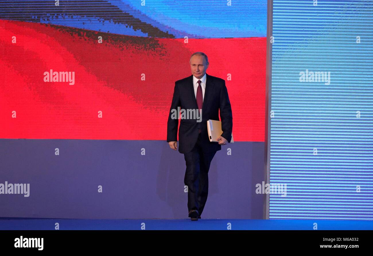 Russian President Vladimir Putin walks on to the stage to deliver the ...