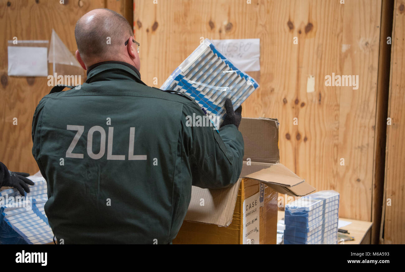28 February 2018, Germany, Frankfurt: A German customs officer sors ...