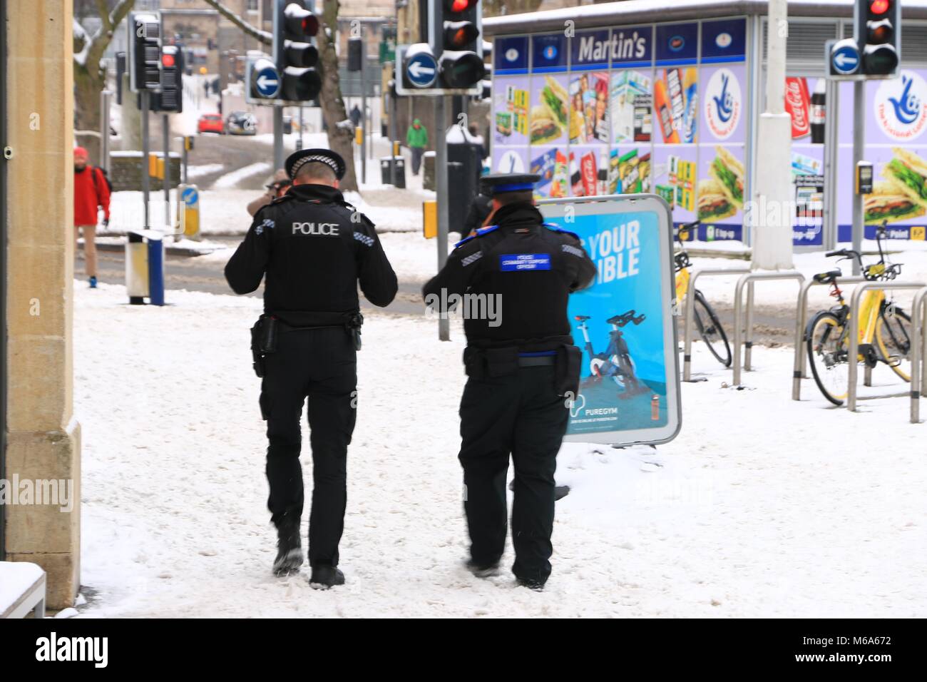 Two police officers walking through the snow in Bristol Stock Photo - Alamy