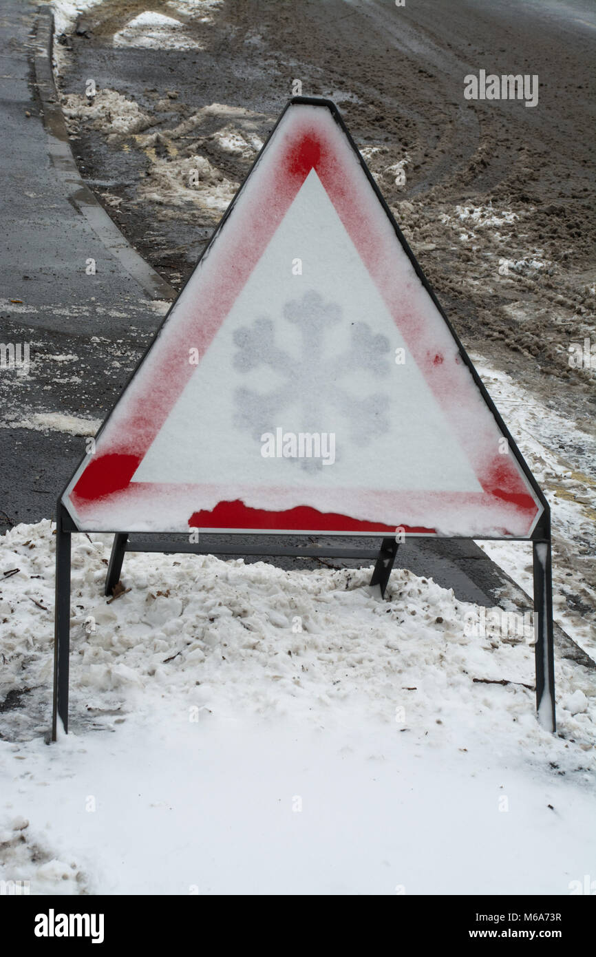 Road sign with snowflake covered with snow Stock Photo - Alamy